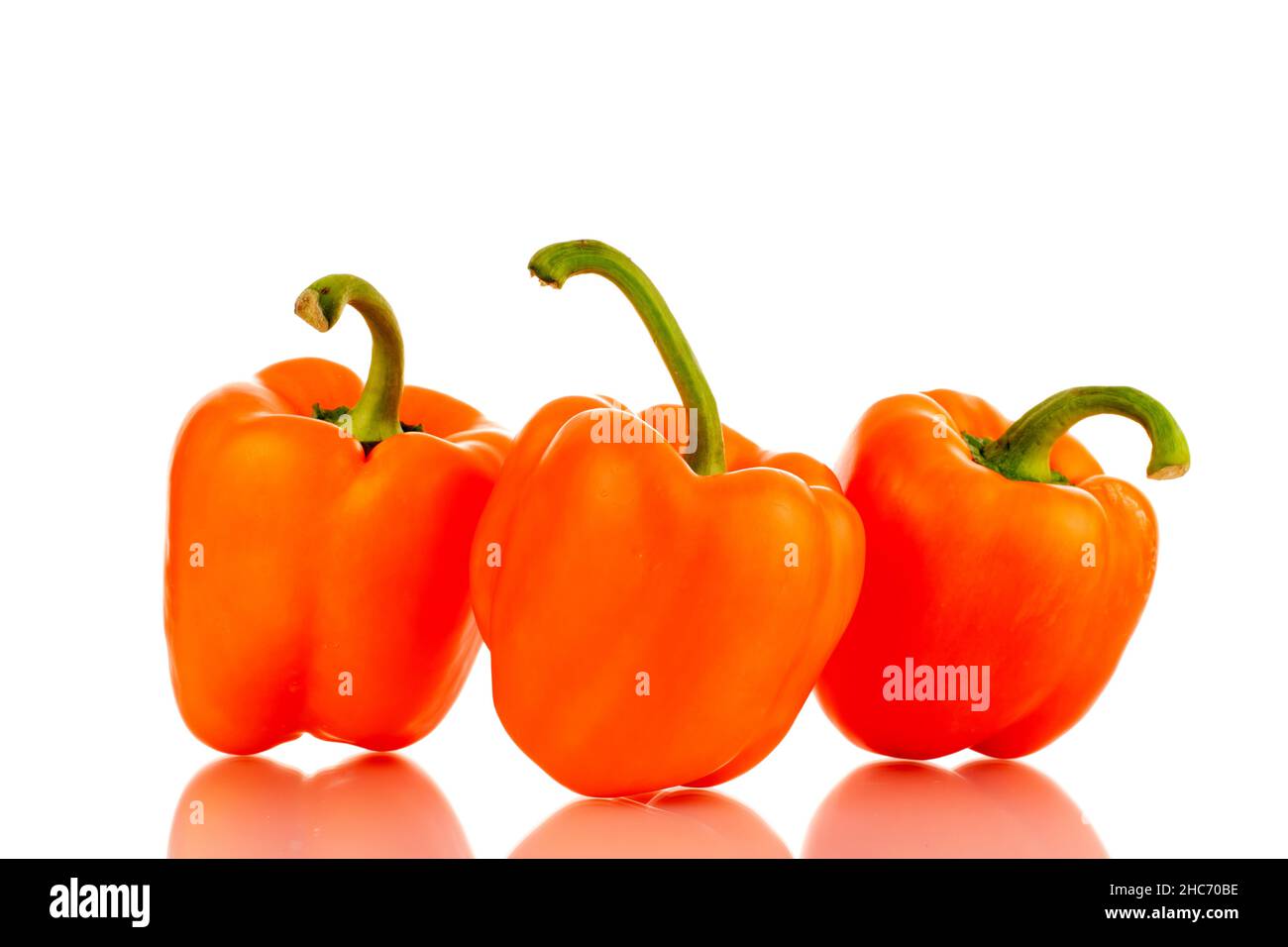 Three ripe orange sweet peppers, close-up, isolated on white Stock ...