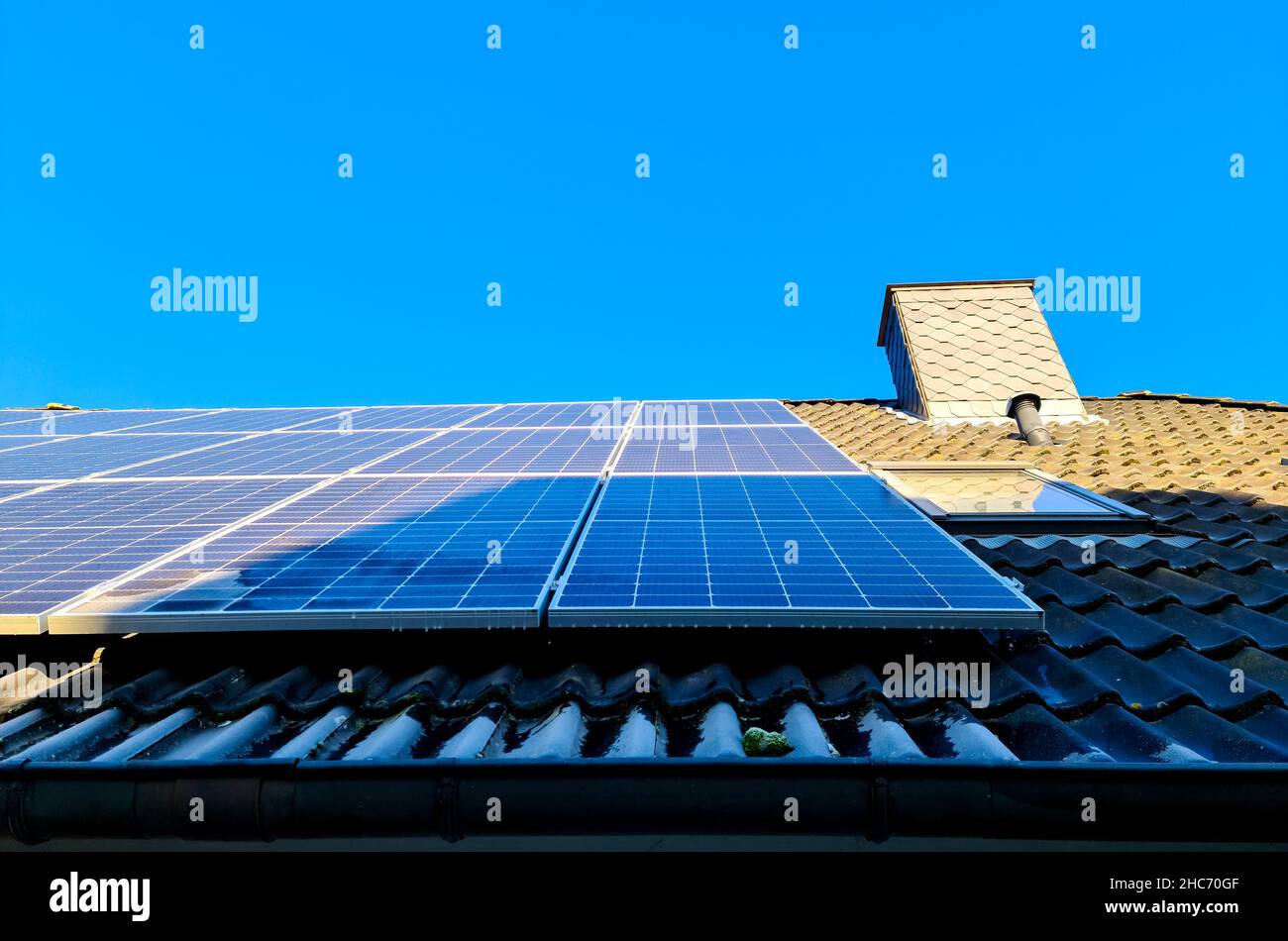 Solar panels producing clean energy on a roof of a residential house ...