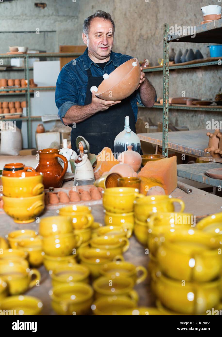 Happy potter at the workshop Stock Photo - Alamy