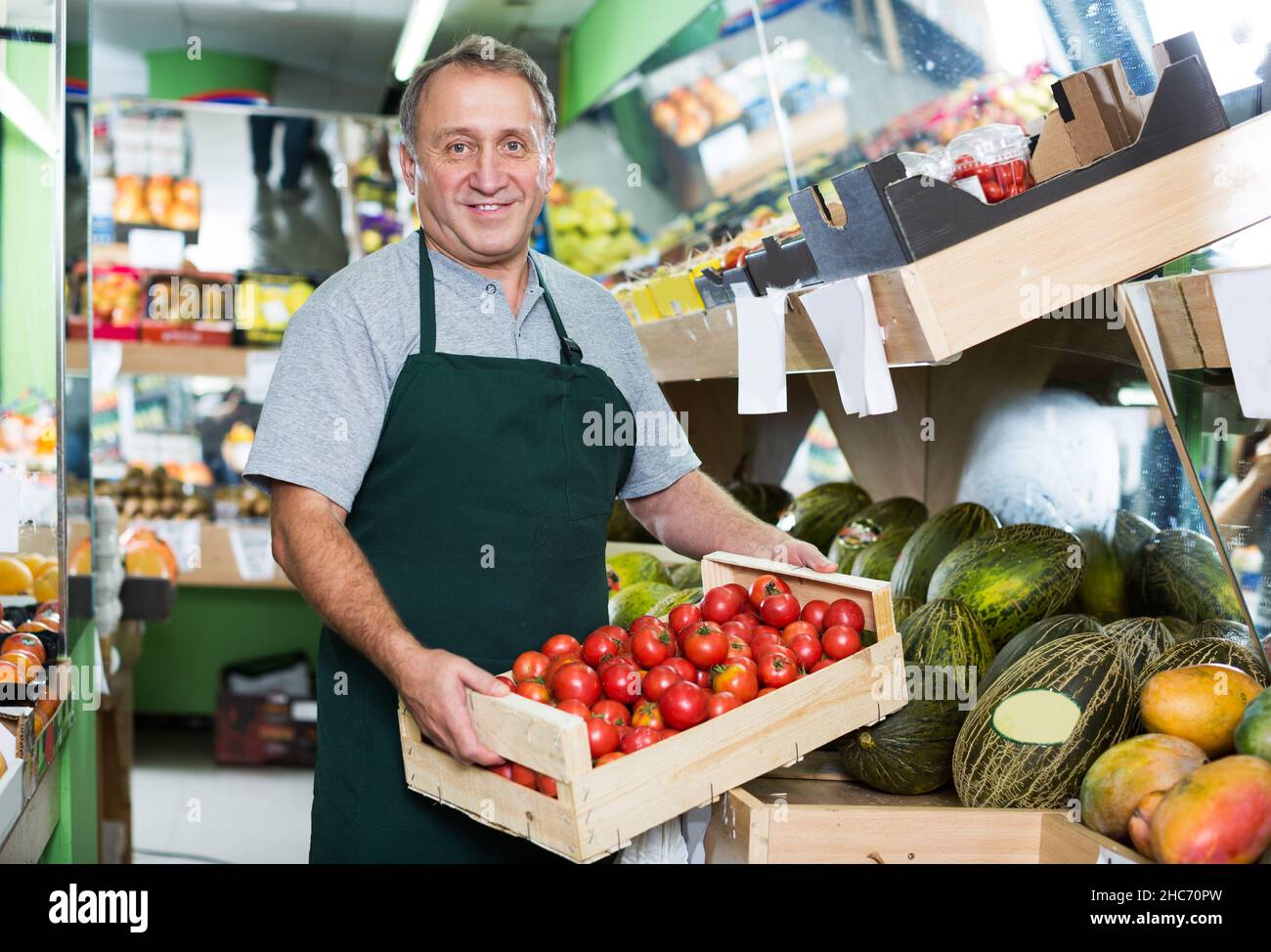 Adult seller offering red hi-res stock photography and images - Alamy