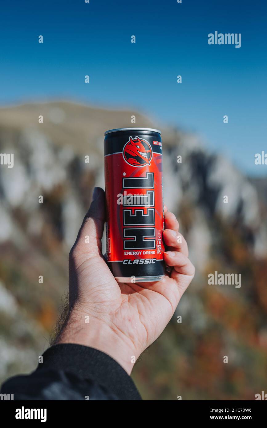 Vertical shot of a person holding a Hell energizer coffee Stock Photo ...