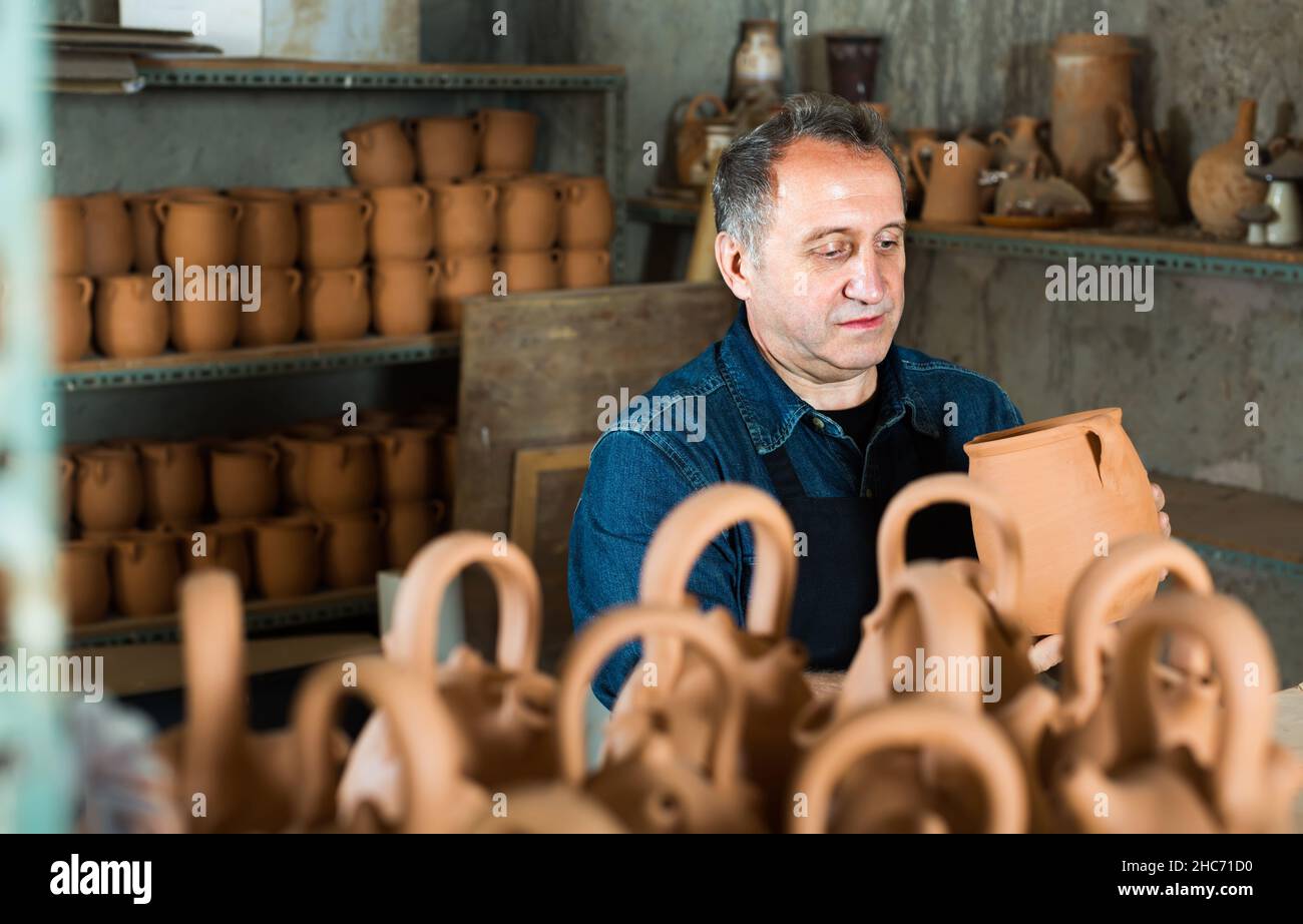 Elderly master at pottery workshop Stock Photo - Alamy