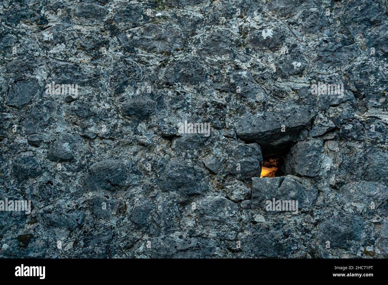 loophole in the ancient fortress wall through which light breaks Stock ...