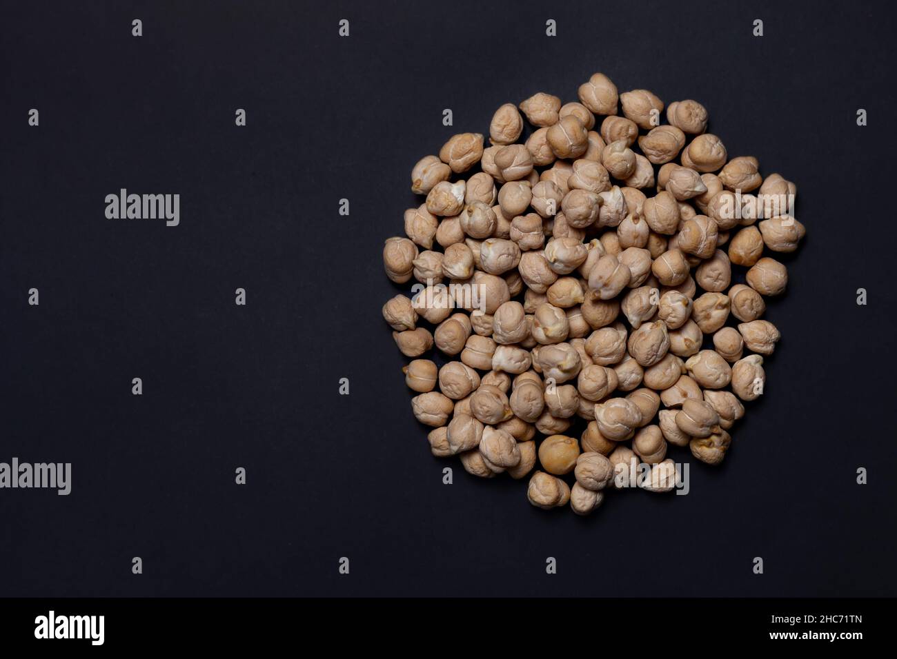 Raw chickpeas close-up on a black background. Isolated Stock Photo - Alamy