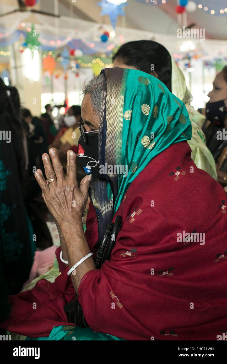 A Christian Devotee wearing a masks attend prayers at a Holy Rosary ...