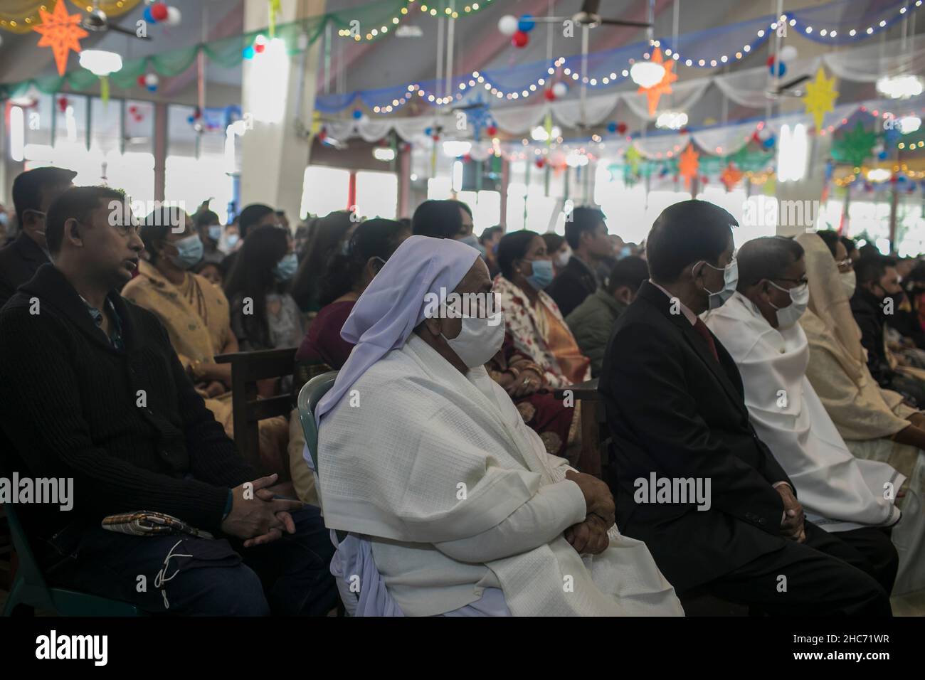 Christian Devotees wearing masks attend prayers at a Holy Rosary ...