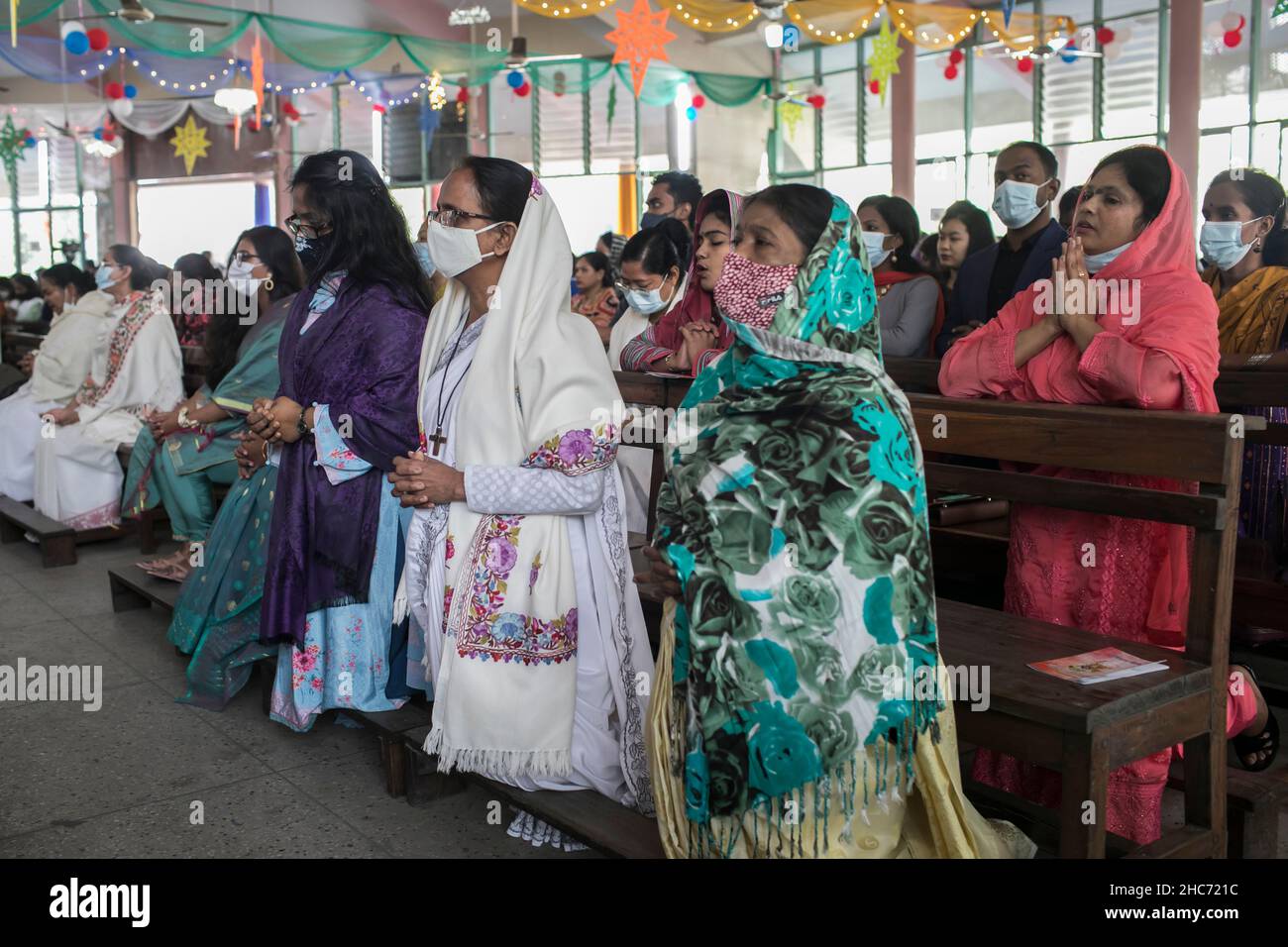 Christian Devotees wearing masks attend prayers at a Holy Rosary ...