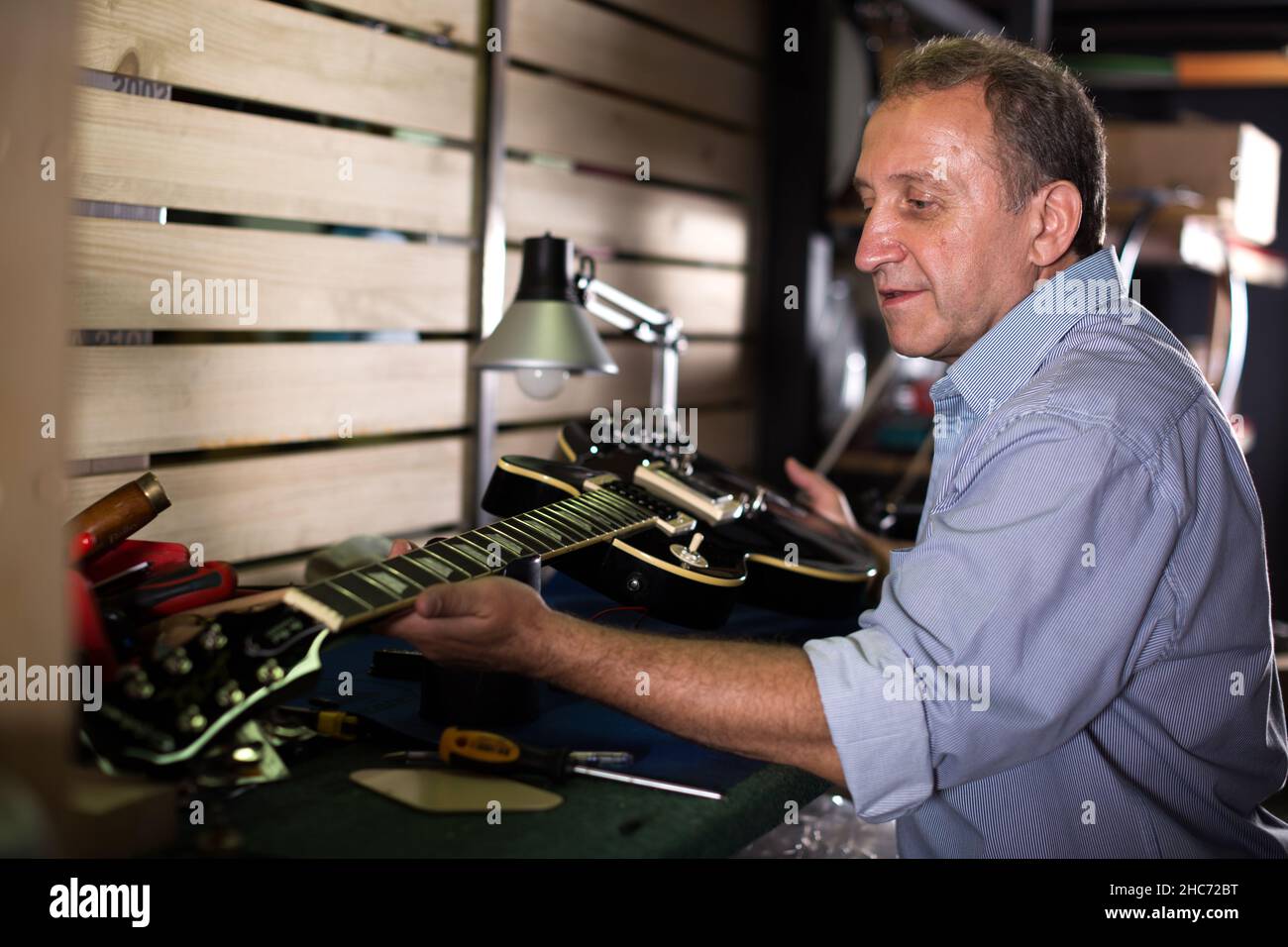 Music master is repairing music instruments Stock Photo - Alamy