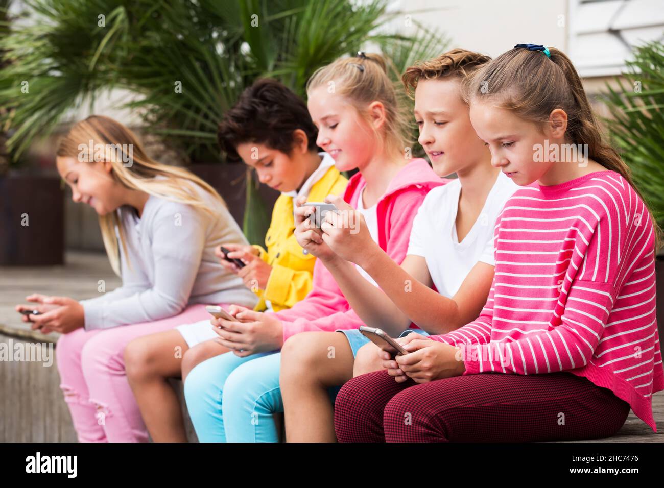 Children playing on smartphone outdoors Stock Photo - Alamy