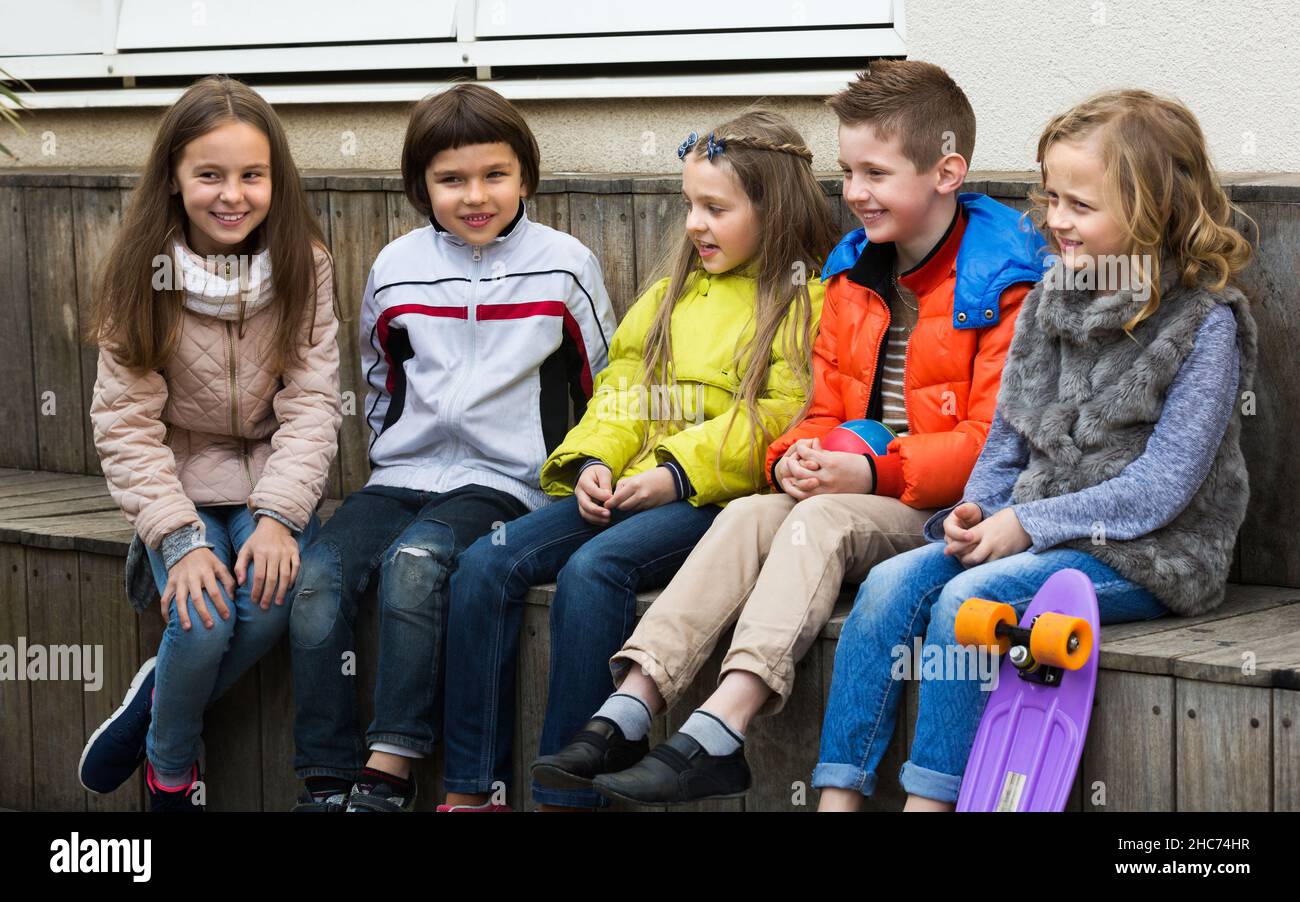Kids sharing secrets as talking Stock Photo - Alamy