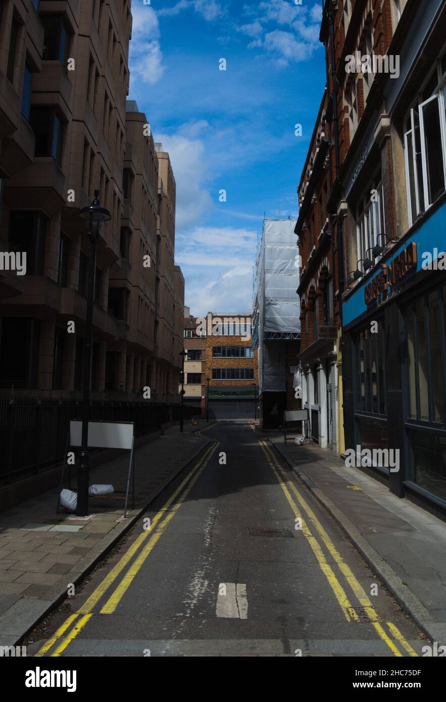 Iconic double yellow lines on the street and deep blue sky in London ...