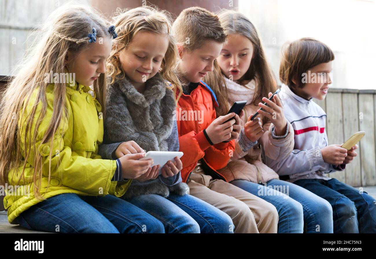 Children playing with mobile phones Stock Photo - Alamy