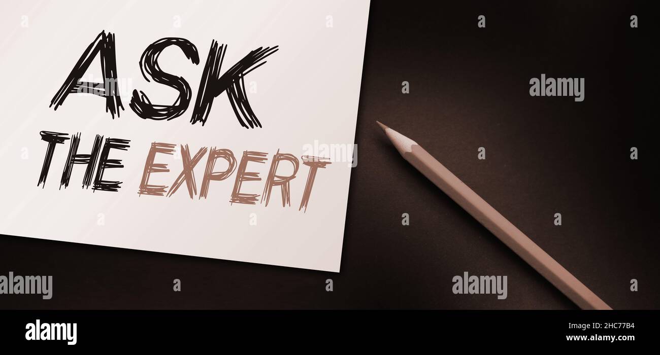 Ask the Expert Text written on notebook page, red pencil on the right ...