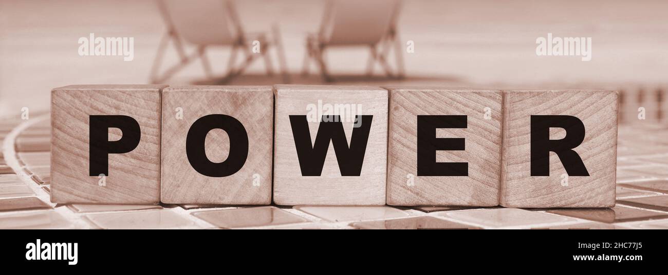 POWER message word on a wooden cube blocks with a ocean beach ...