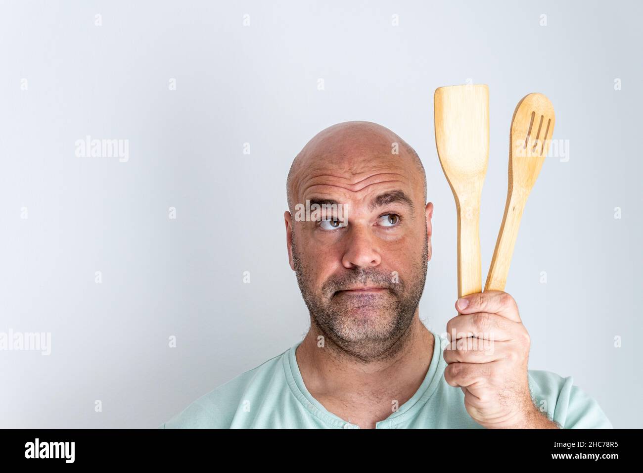 Close-up shot of a face of a bald and bearded Caucasian man with some ...