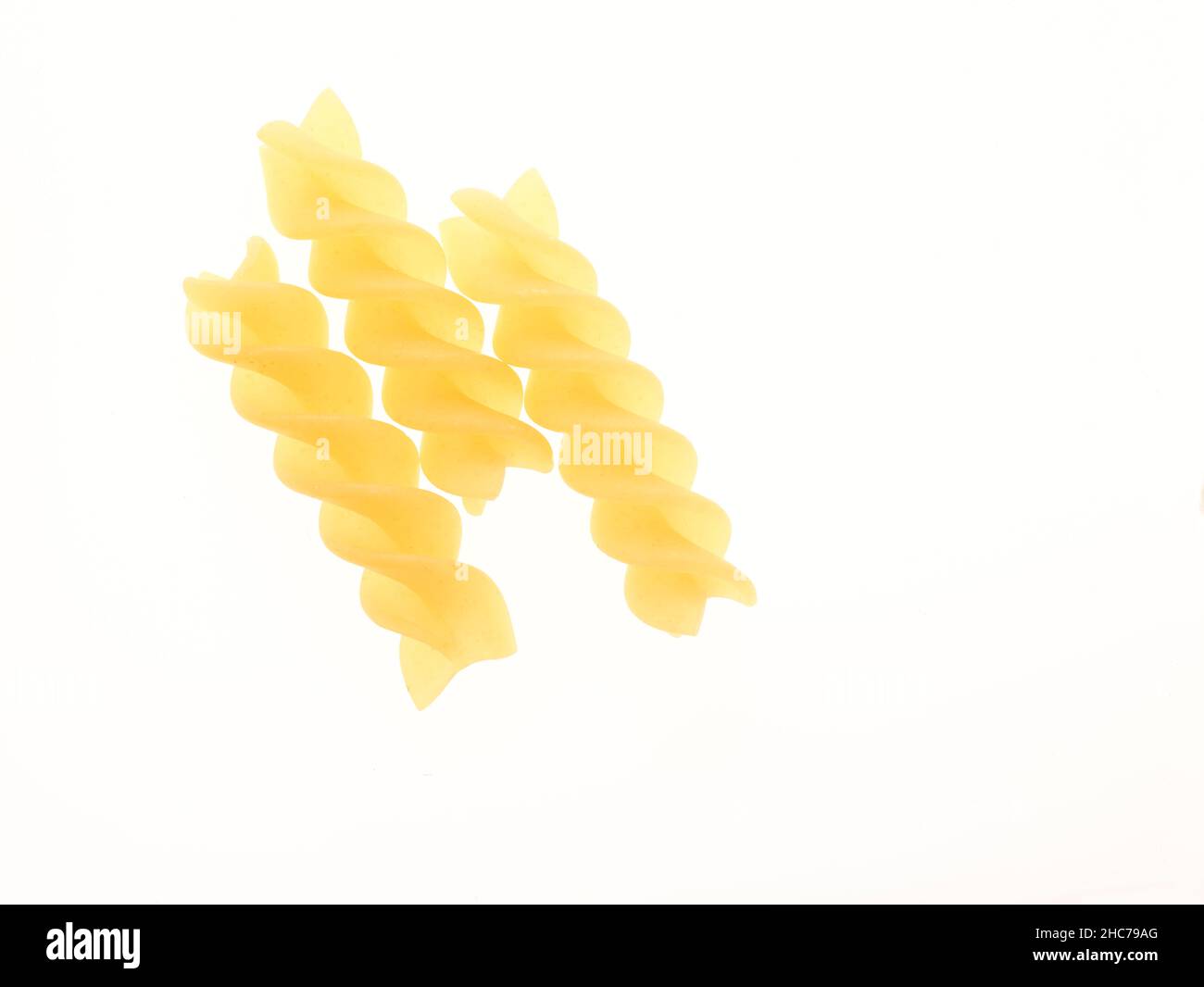 Macro food still life of Fusilli, fuˈzilli, pasta on plain background ...