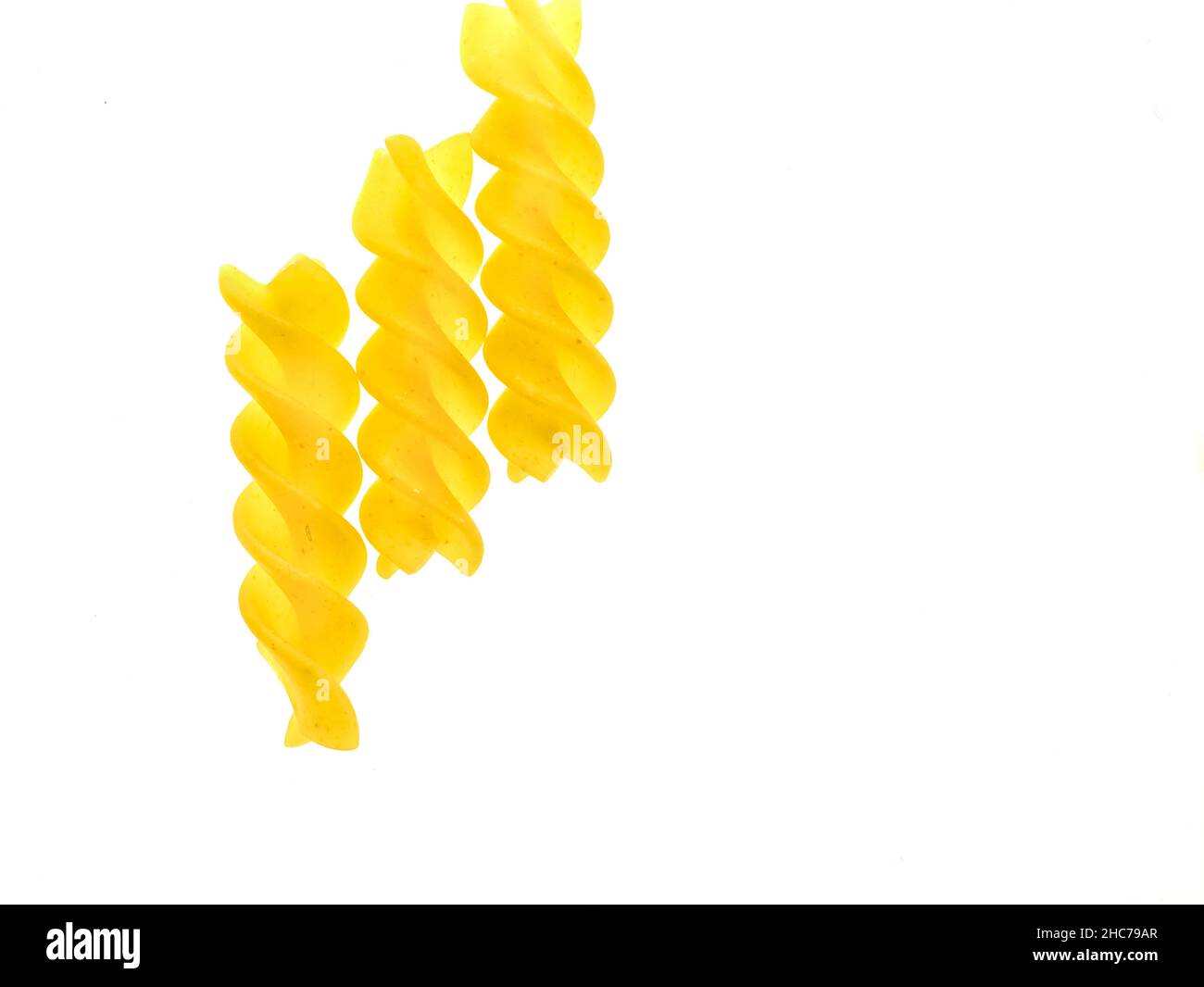 Macro food still life of Fusilli, fuˈzilli, pasta on plain background ...