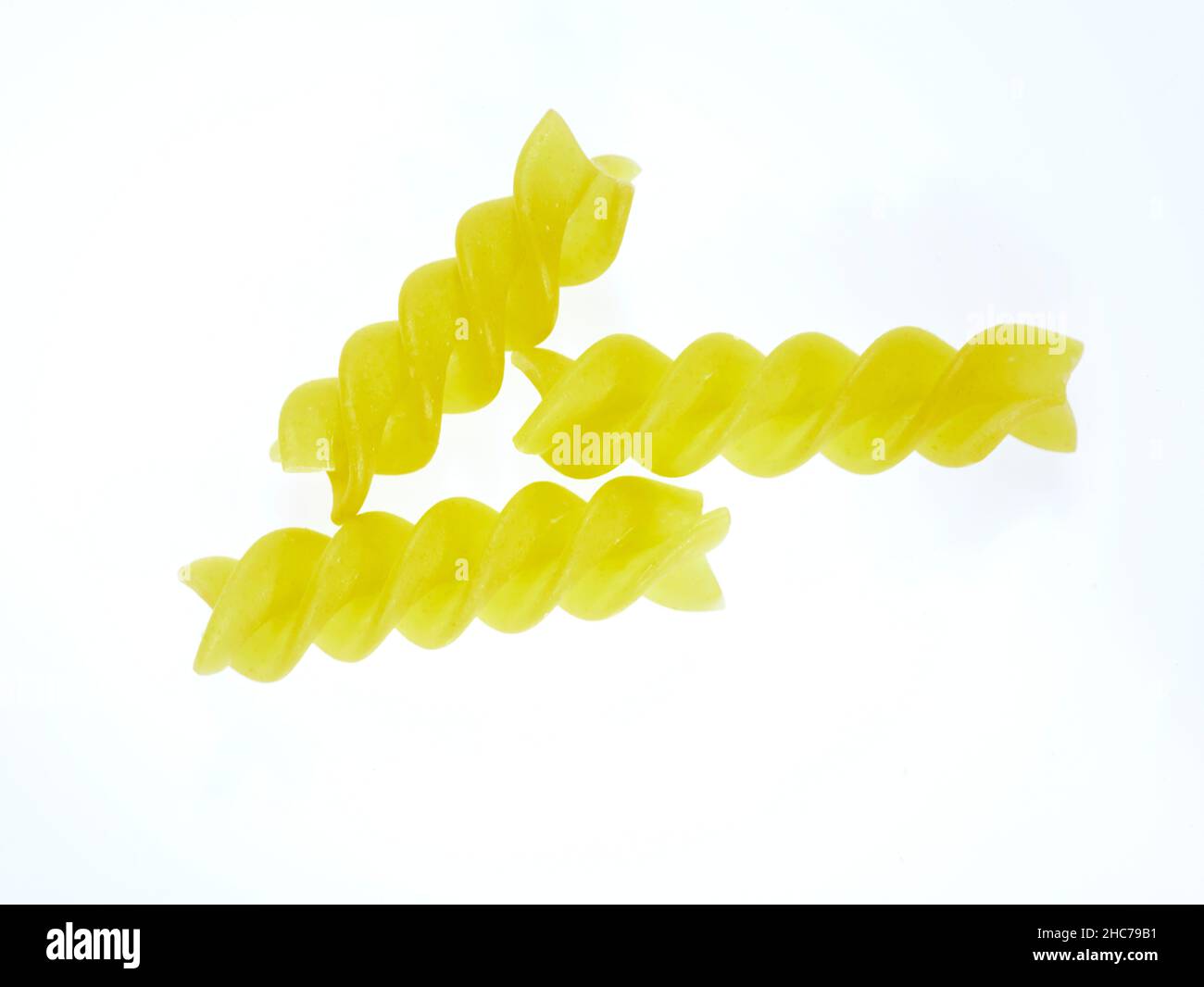Macro food still life of Fusilli, fuˈzilli, pasta on plain background ...