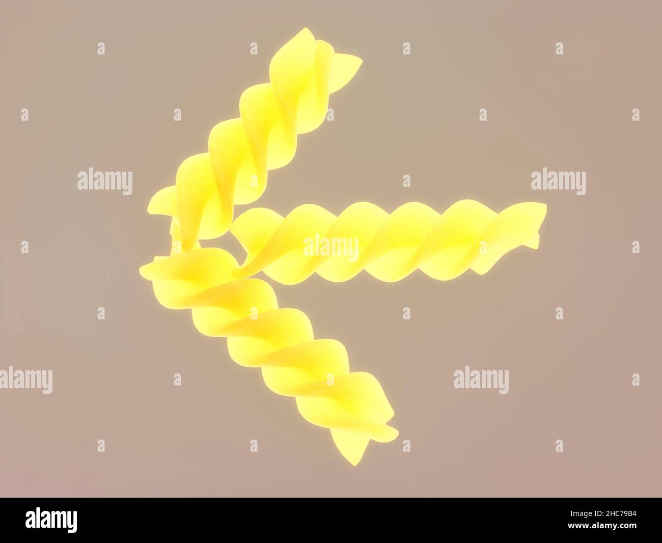 Macro food still life of Fusilli, fuˈzilli, pasta on plain background ...
