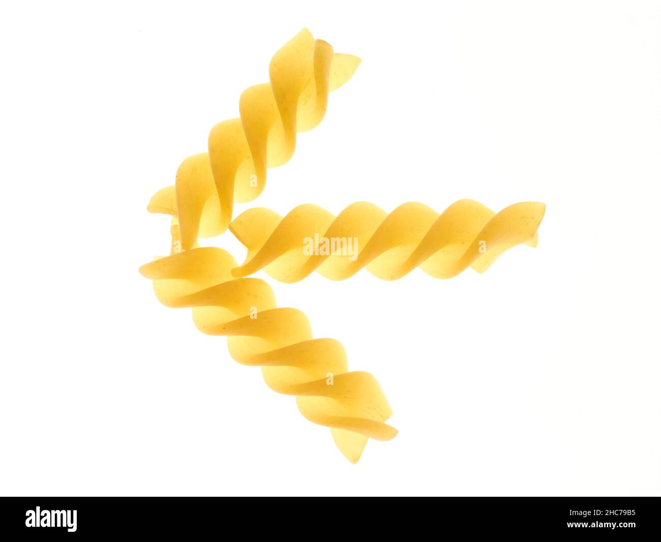 Macro food still life of Fusilli, fuˈzilli, pasta on plain background ...