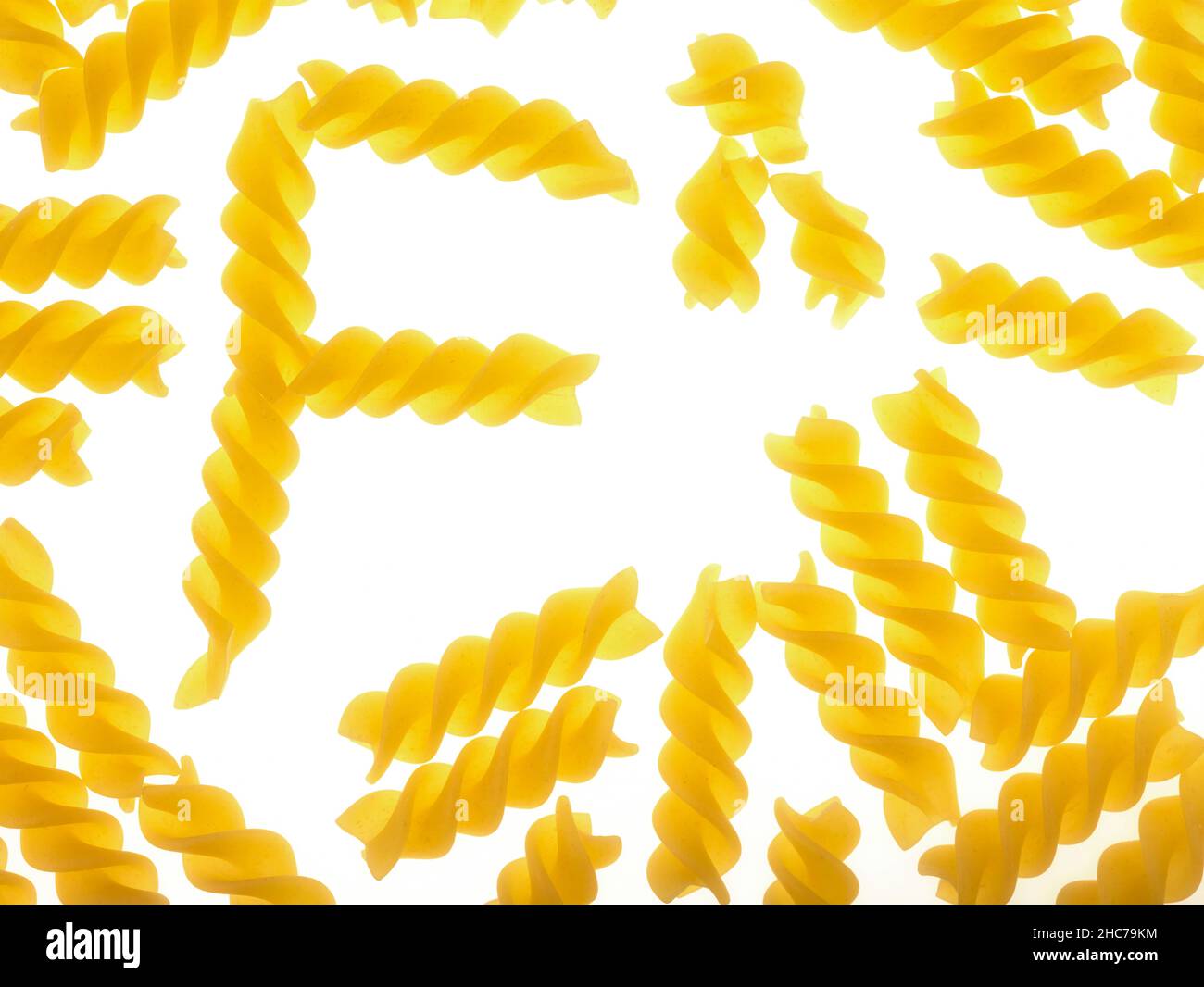 Macro food still life of Fusilli, fuˈzilli, pasta on plain background ...