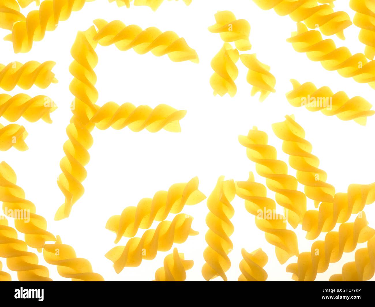 Macro food still life of Fusilli, fuˈzilli, pasta on plain background ...