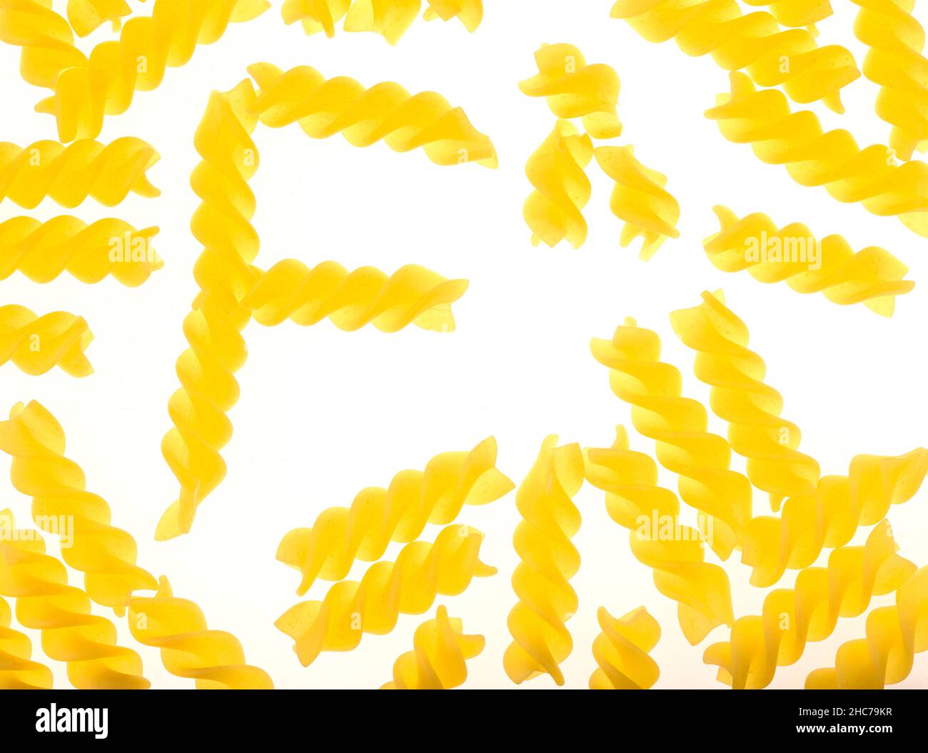 Macro food still life of Fusilli, fuˈzilli, pasta on plain background ...