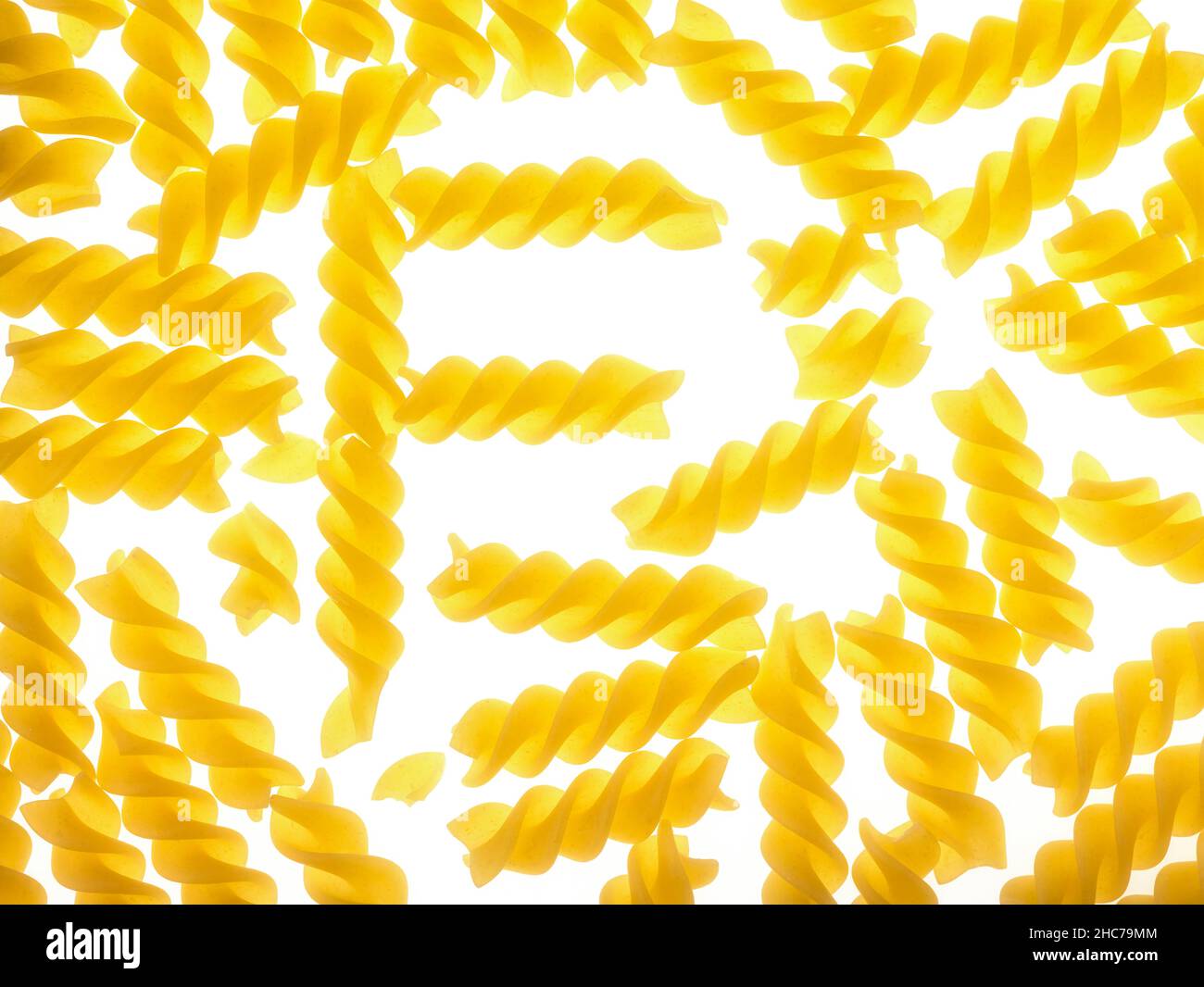 Macro food still life of Fusilli, fuˈzilli, pasta on plain background ...