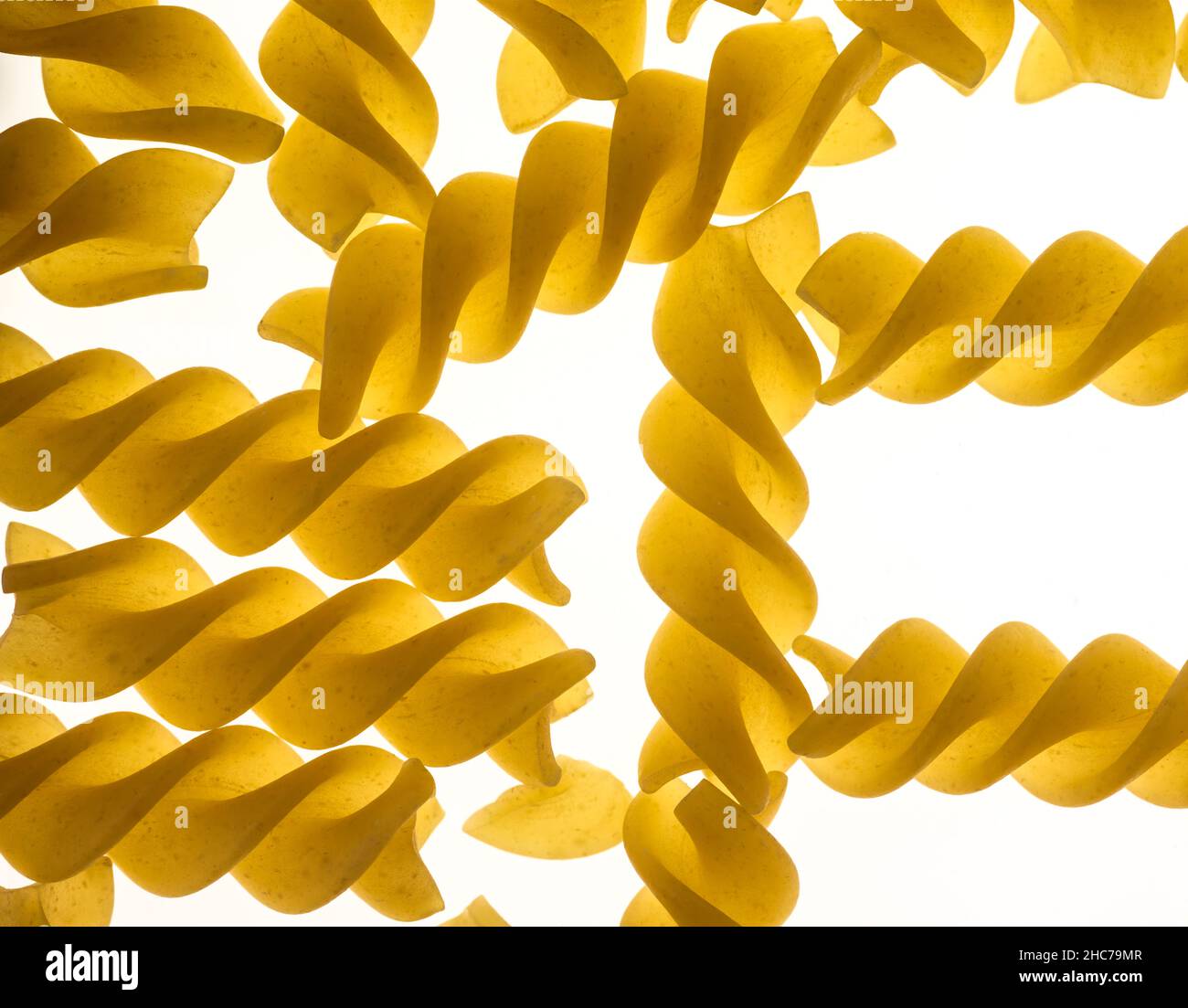Macro food still life of Fusilli, fuˈzilli, pasta on plain background ...