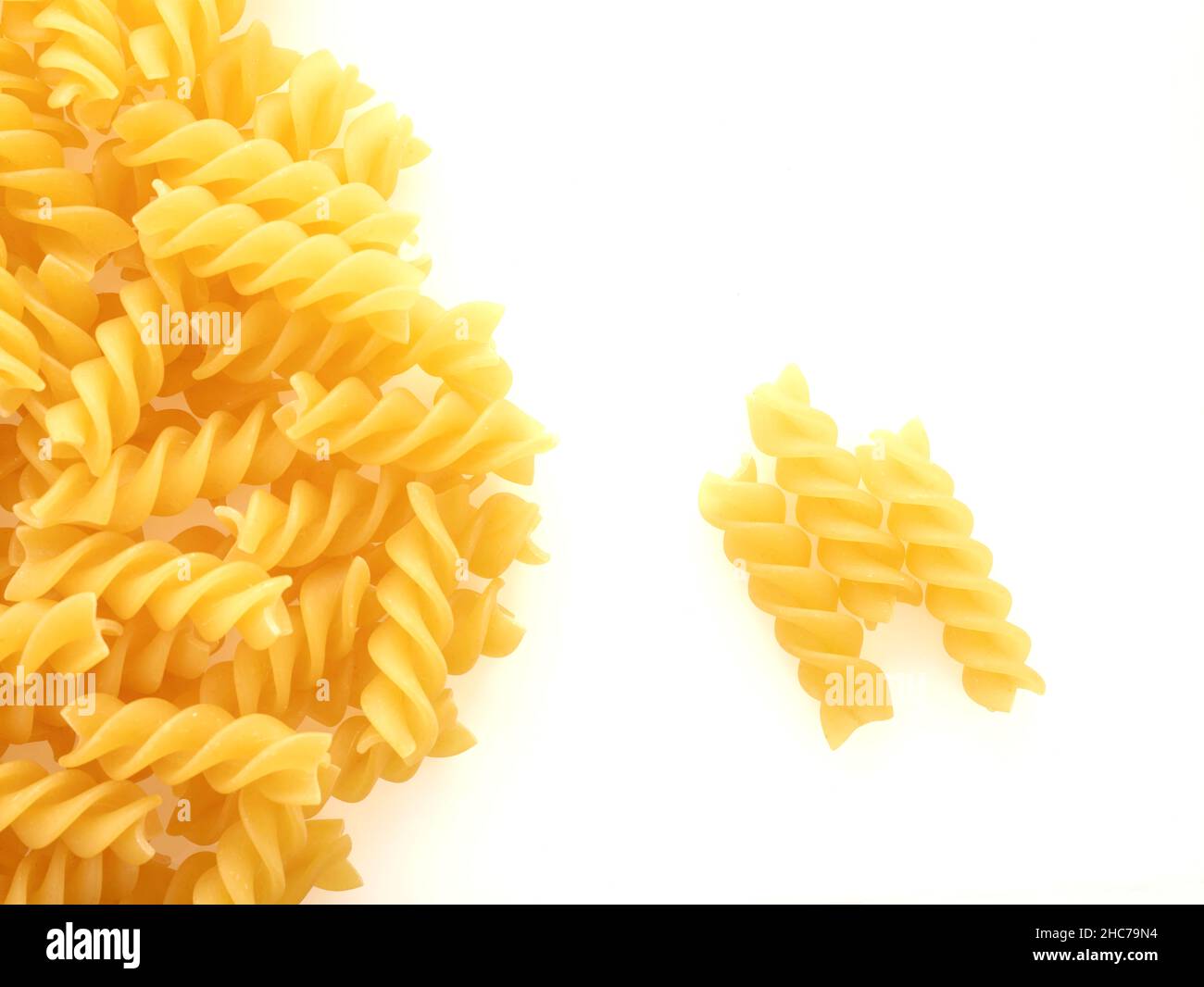 Macro food still life of Fusilli, fuˈzilli, pasta on plain background ...