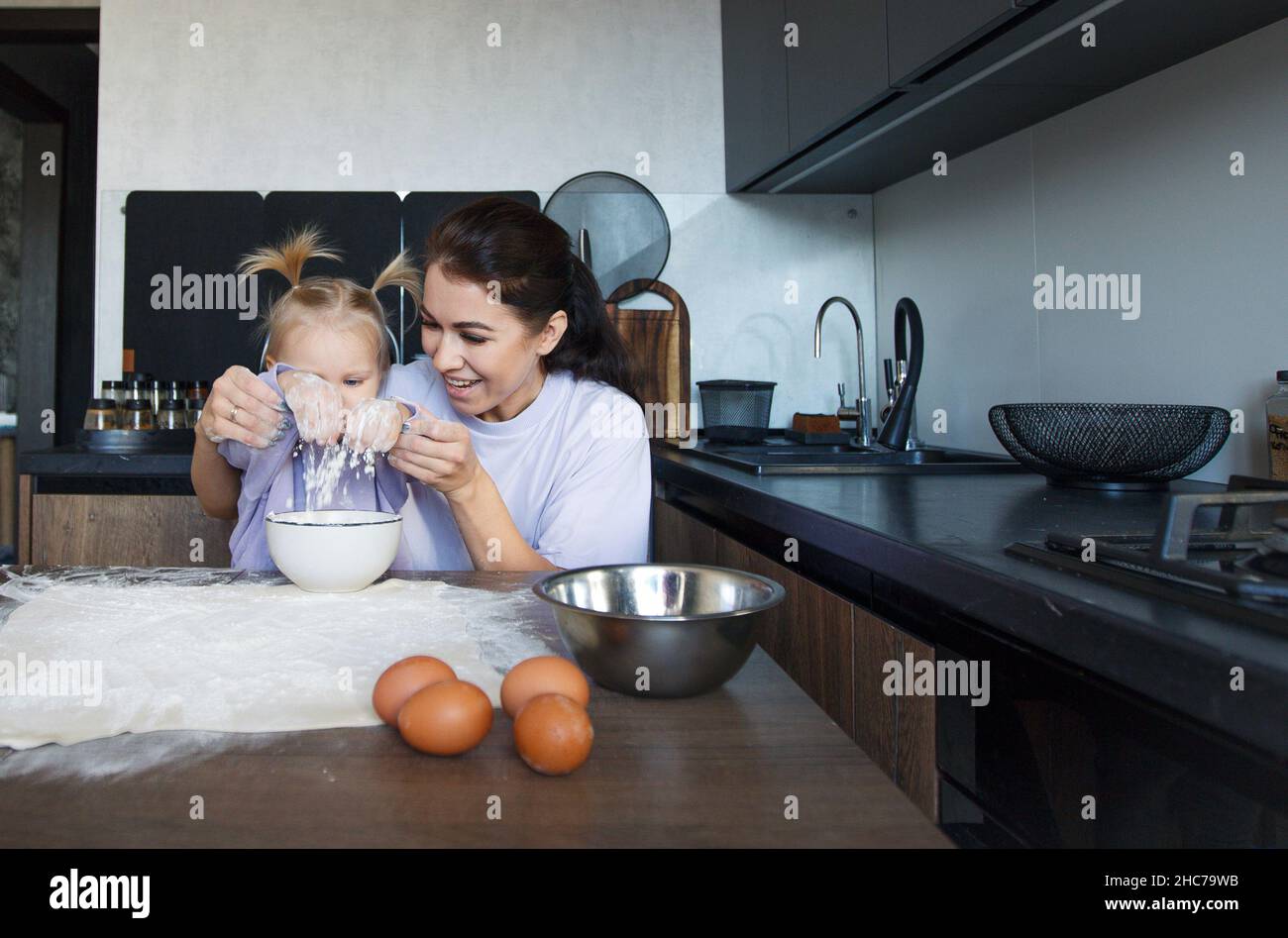 Happy loving family cooking bakery together. Mother and daughter-girl ...