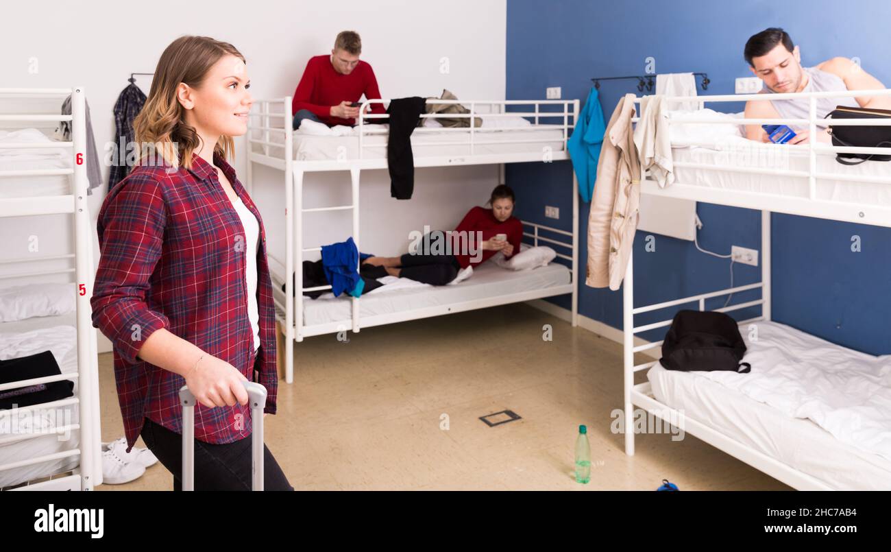 Young woman coming to hostel Stock Photo - Alamy