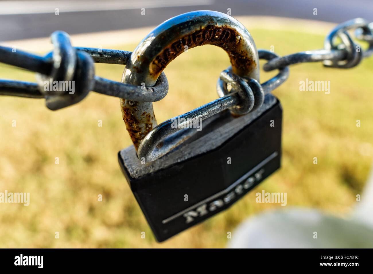 Master lock lining two chains together Stock Photo - Alamy