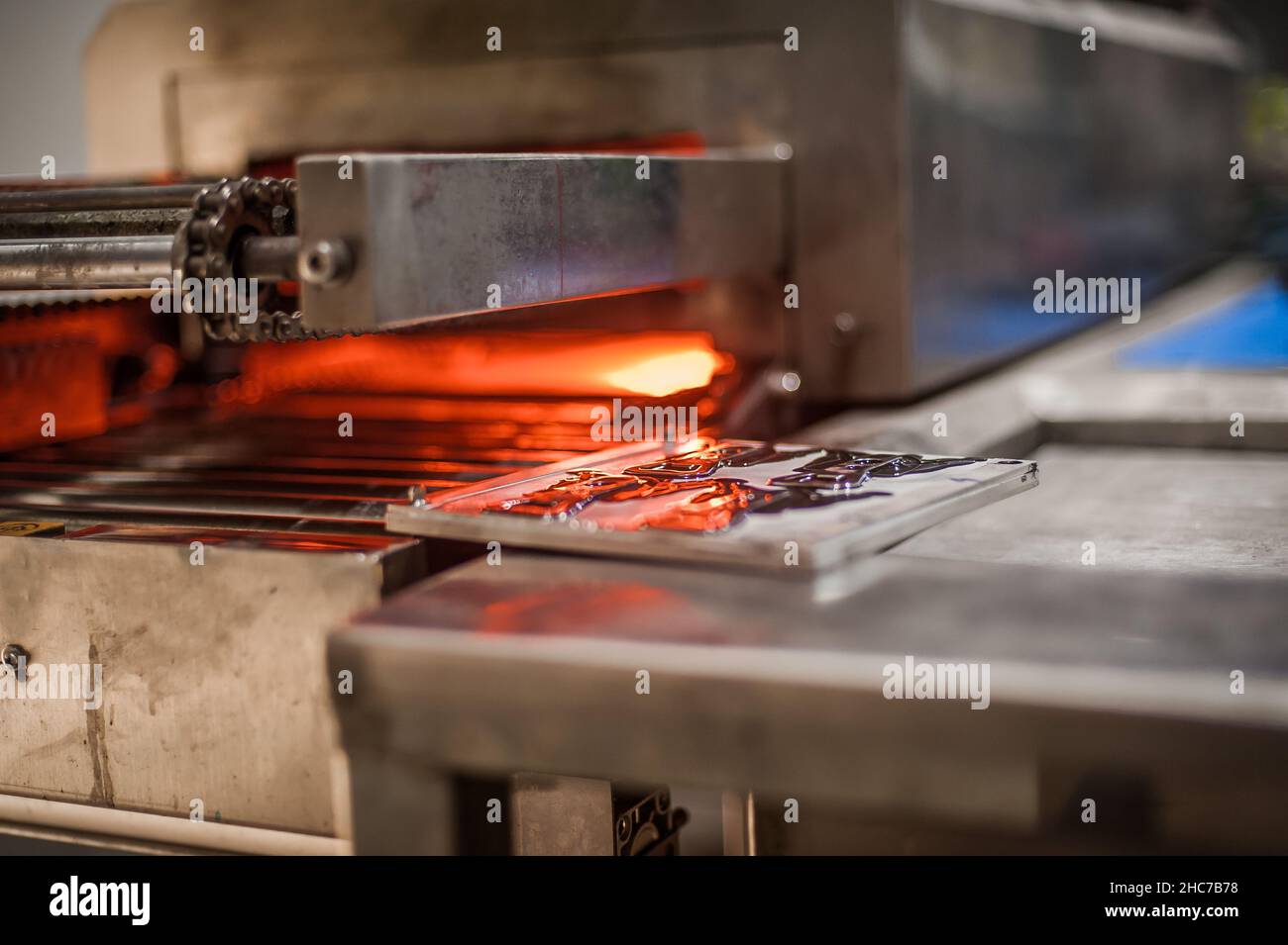 Closeup view of automatic heater stove heating PVC machine in factory ...