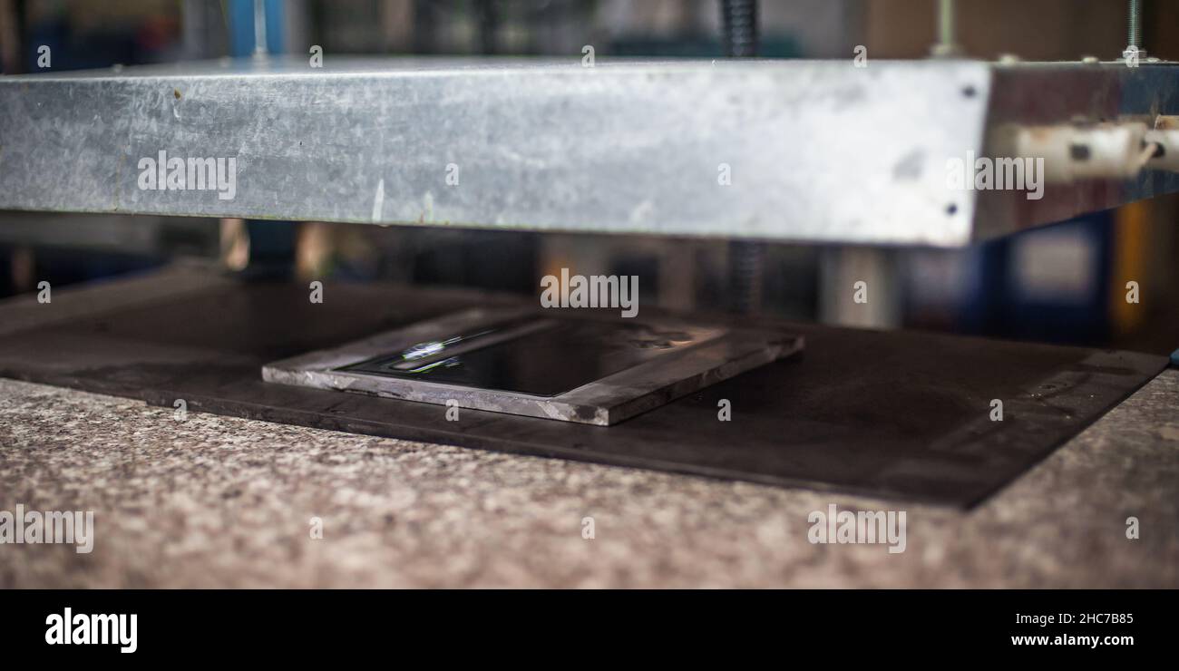 Closeup view of automatic heater stove heating PVC machine in factory ...