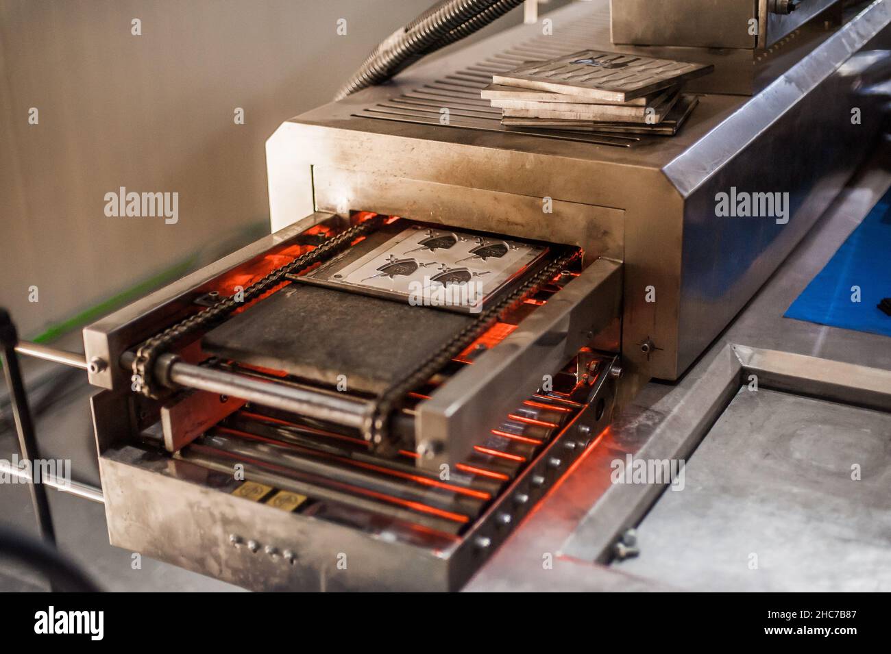 Closeup view of automatic heater stove heating PVC machine in factory ...