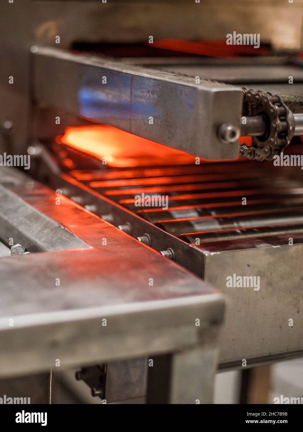 Closeup view of automatic heater stove heating PVC machine in factory ...