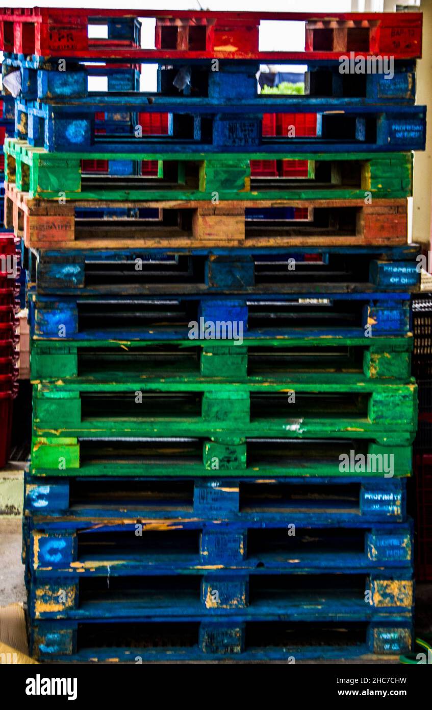 Vertical shot of old colorful wooden pallets arranged on each other ...