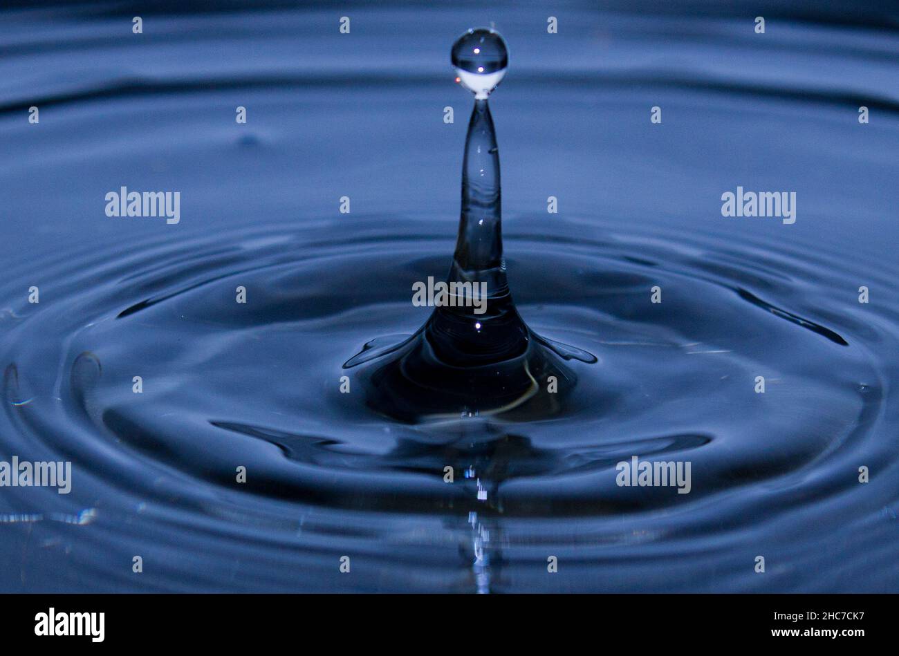 Droplet splashing on the water surface Stock Photo - Alamy