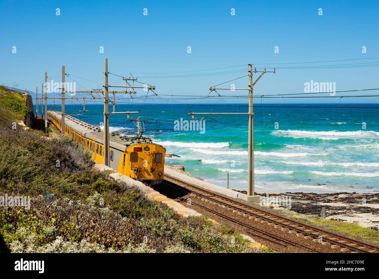 Beautiful shot of a passenger railway running along beach in small ...