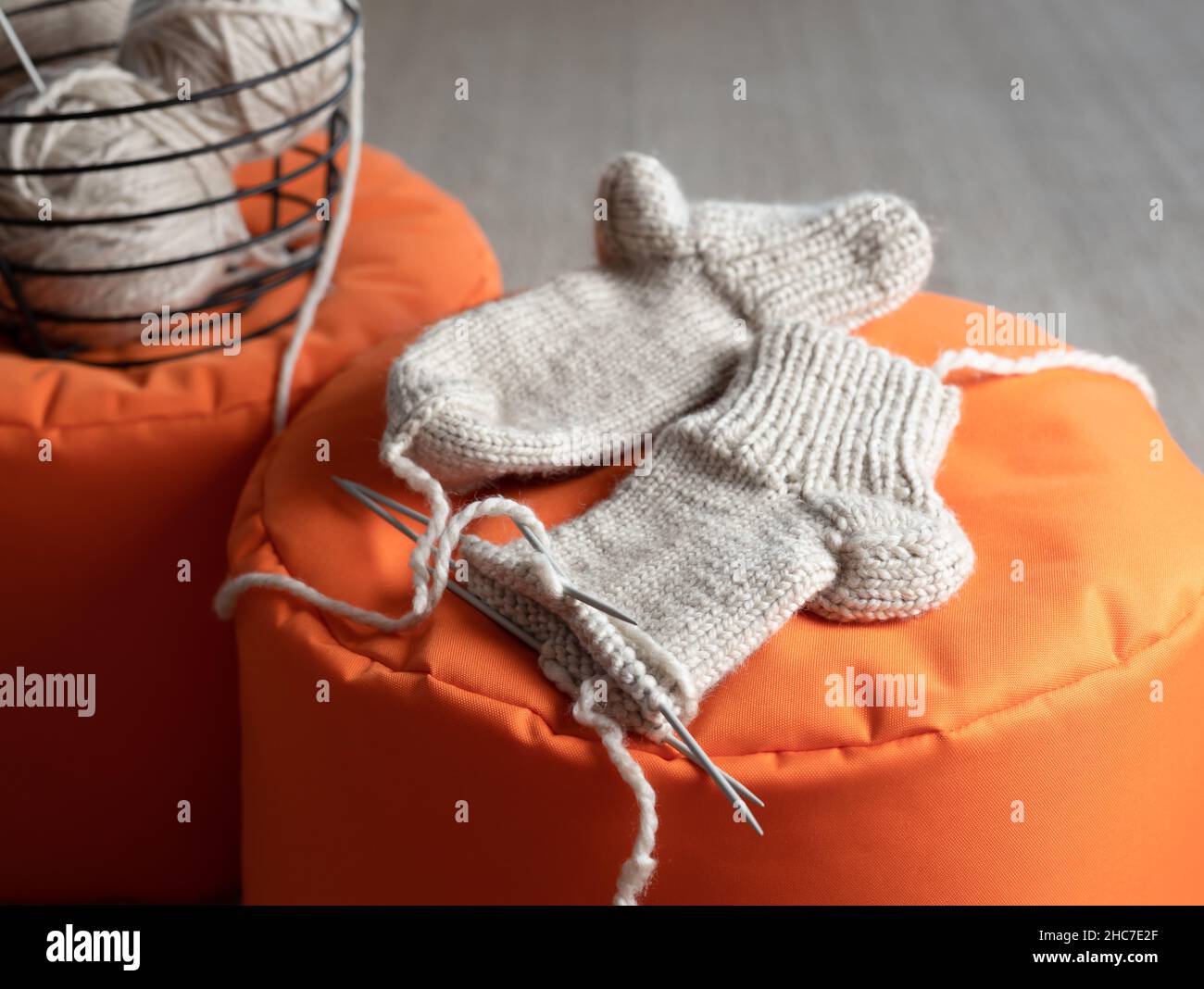Woman knits warm woolen socks on knitting needles. The balls of yarn ...