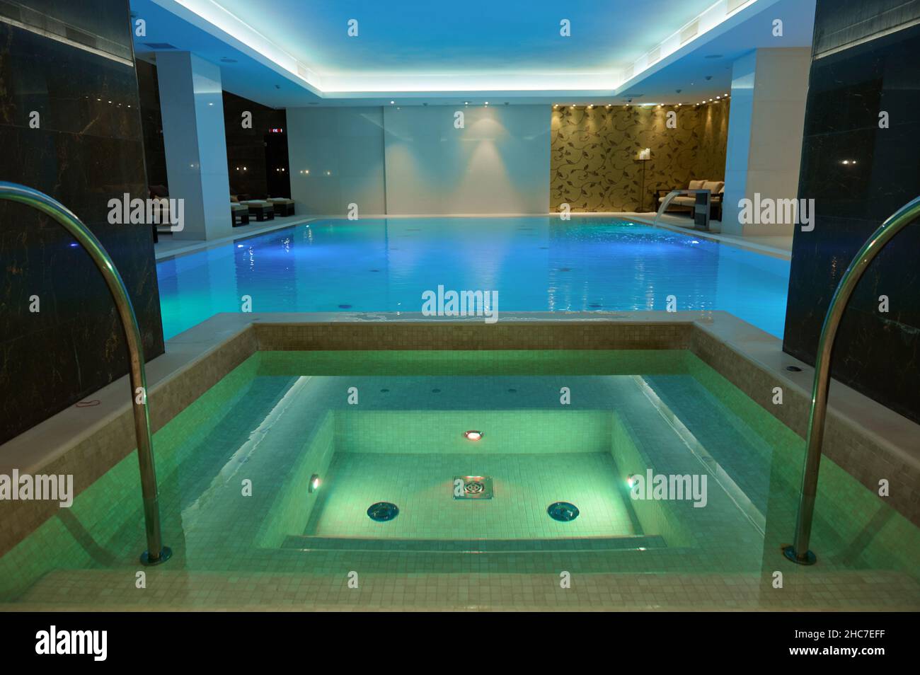 Thermal swimming pool with underwater lights and waterfall in luxury ...