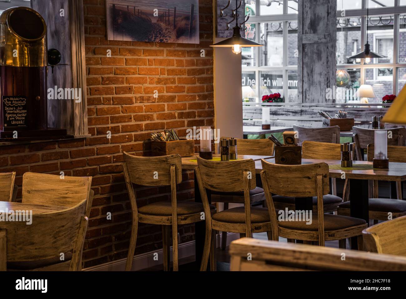 Cafe with empty tables and chairs with grayscale effect on the outside ...