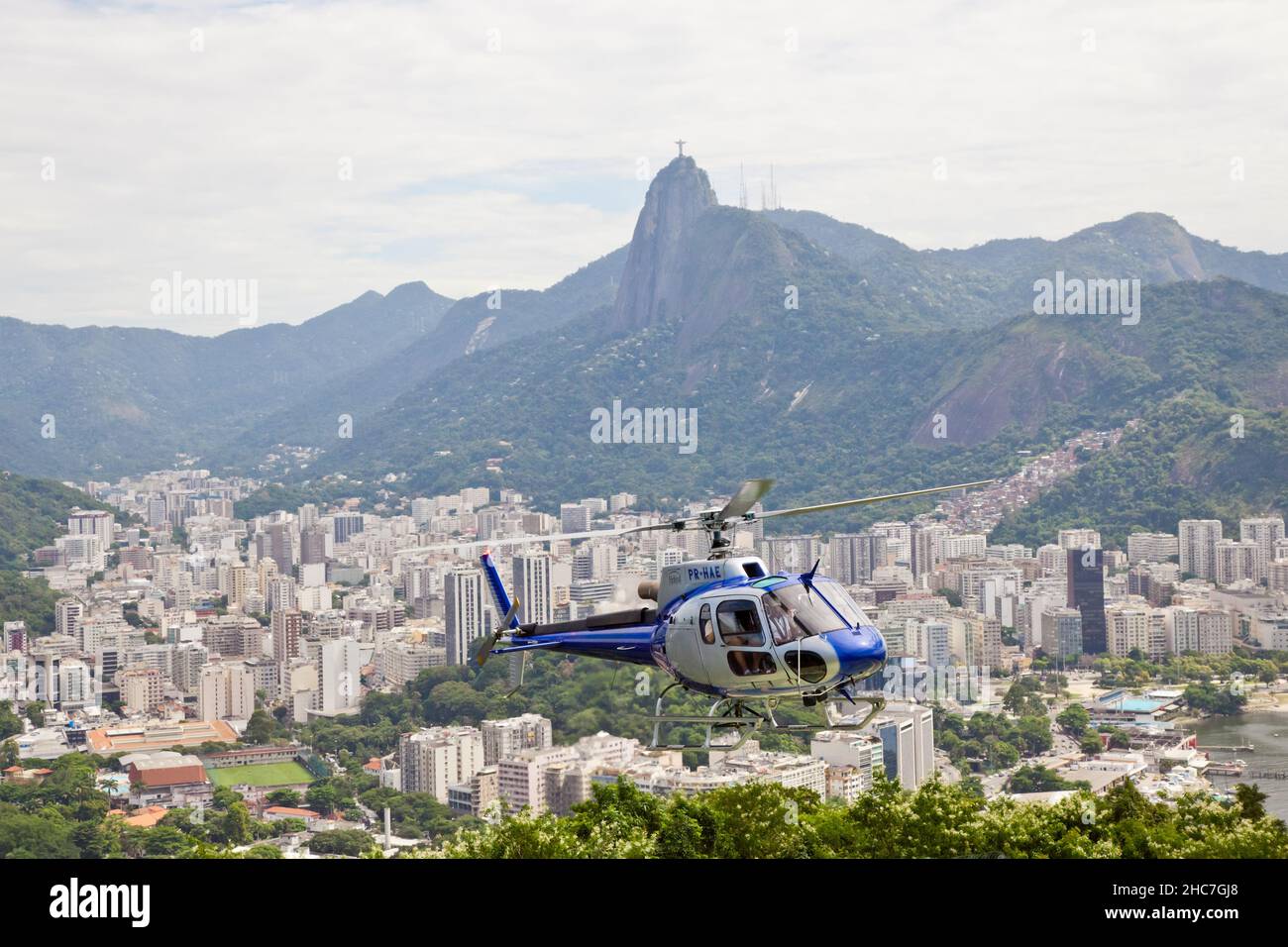 Blue and white helicopter Flying with VIP guests over Rio De Janeiro ...
