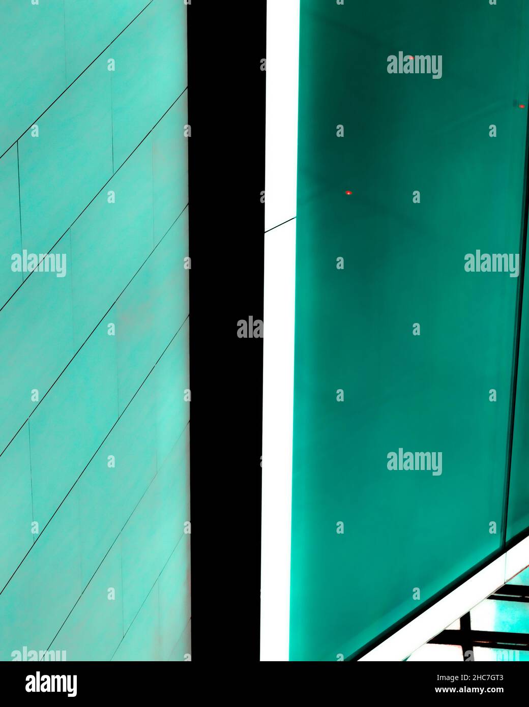 Green light falling on the angle of a wall on dark background Stock ...