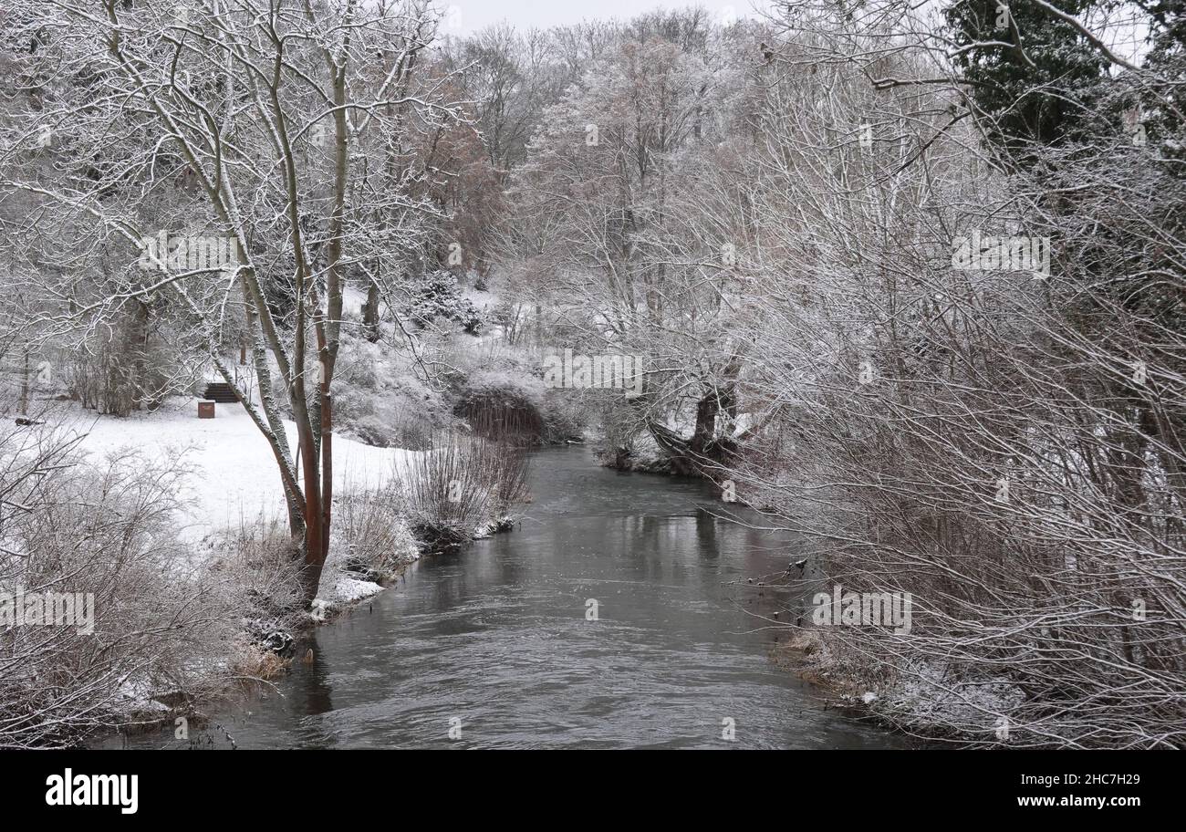 Weimar, Germany. 23rd Dec, 2021. The Ilm flows between snow-covered ...