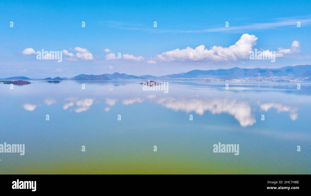Reflection of clear, blue sky on the water surface Stock Photo - Alamy