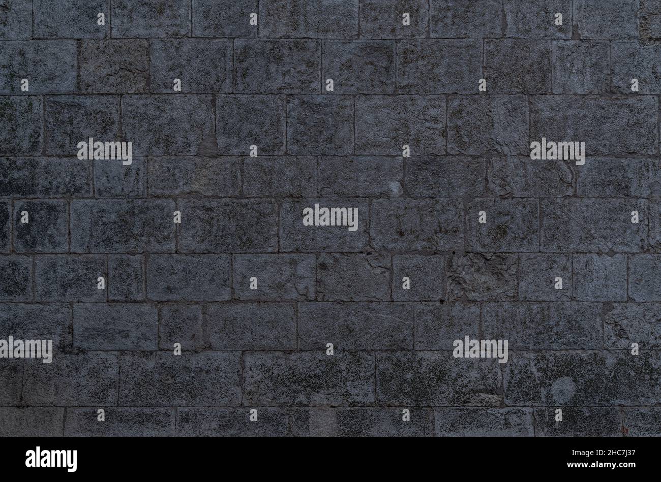 Irregular dark gray bricks dirty and wet wall background Stock Photo ...