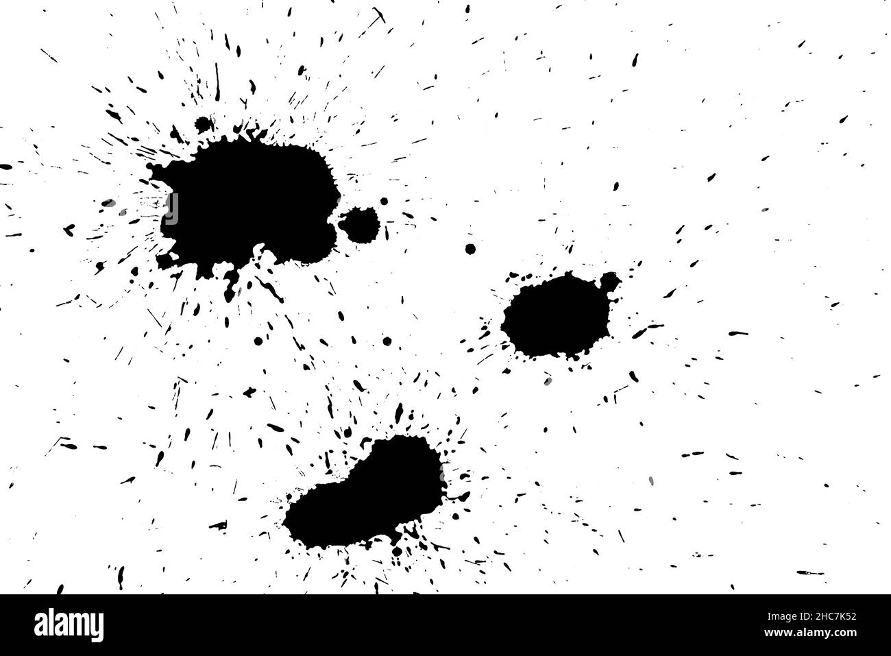 Black blot on a white background. Spots of black ink on a piece of ...