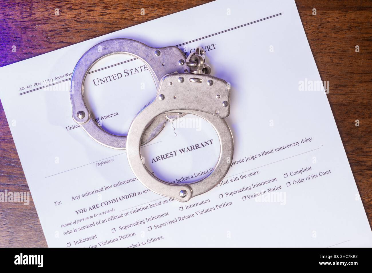 Handcuffs sit on an arrest warrant form Stock Photo - Alamy